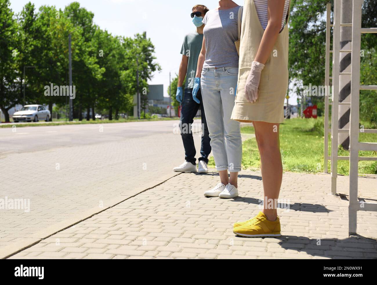 People keeping social distance in line at bus stop. Coronavirus ...
