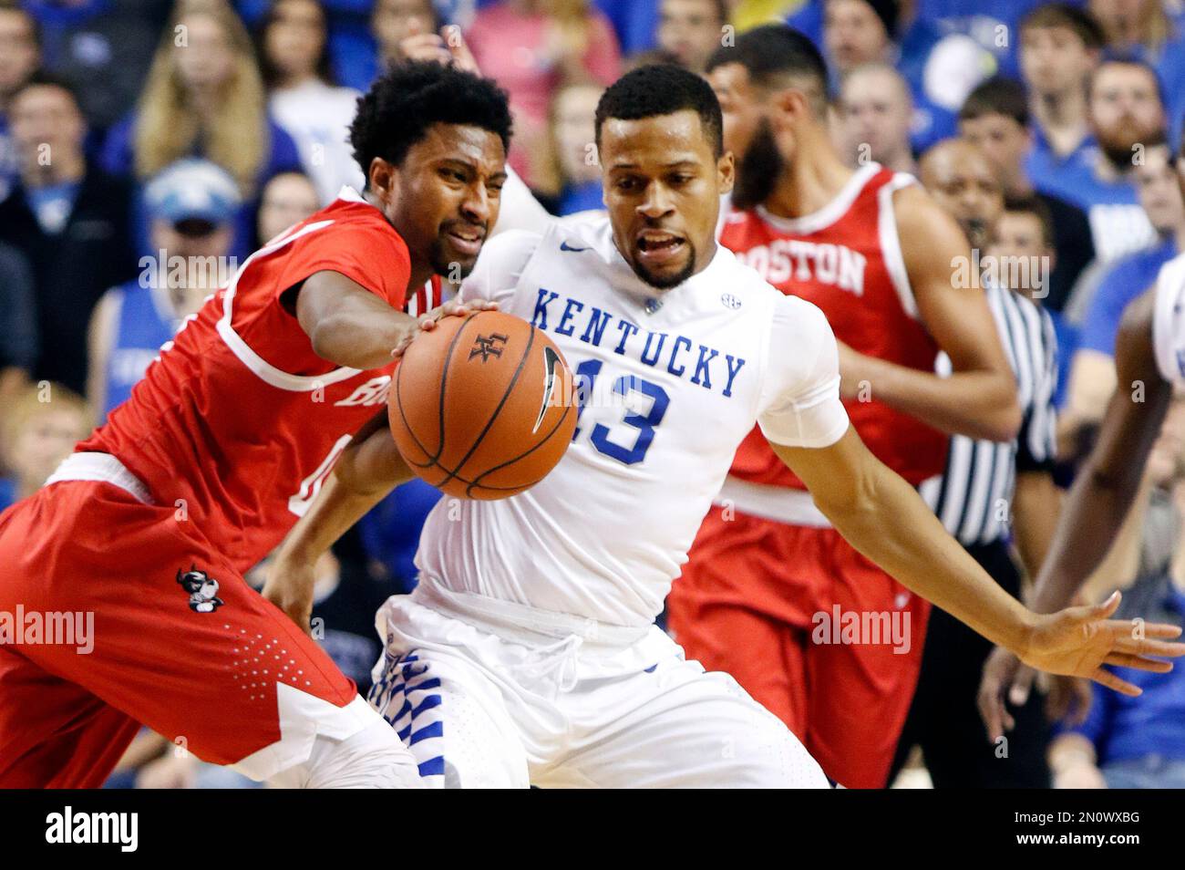 Boston University's Eric Johnson, left, looks for an opening against ...