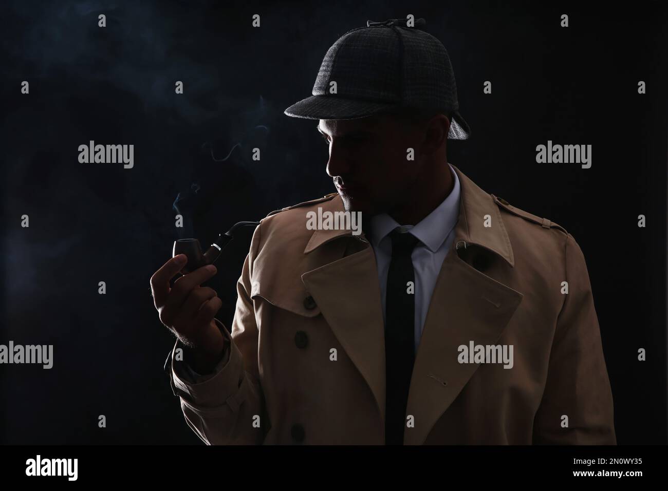 Old fashioned detective smoking pipe on dark background Stock Photo - Alamy