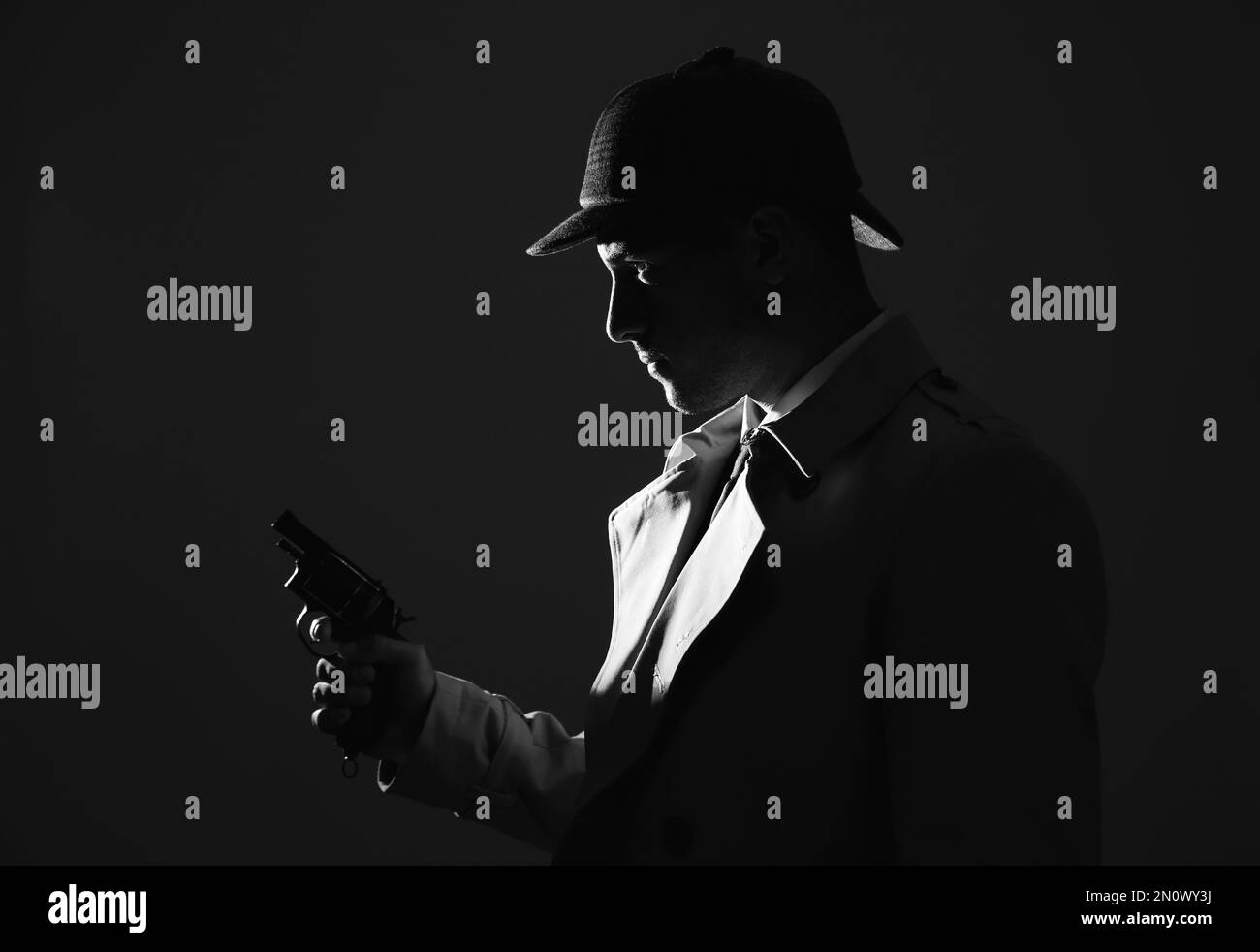 Old fashioned detective with revolver on dark background, black and ...