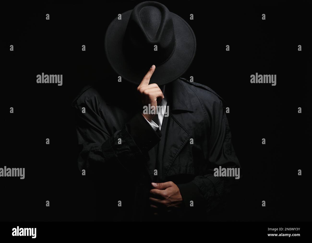 Old fashioned detective in hat on dark background Stock Photo - Alamy