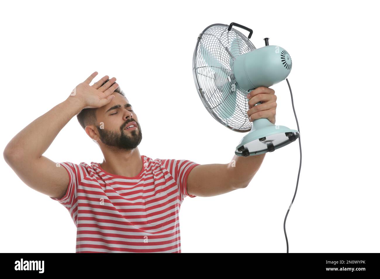 Man with fan suffering from heat on white background. Summer season ...