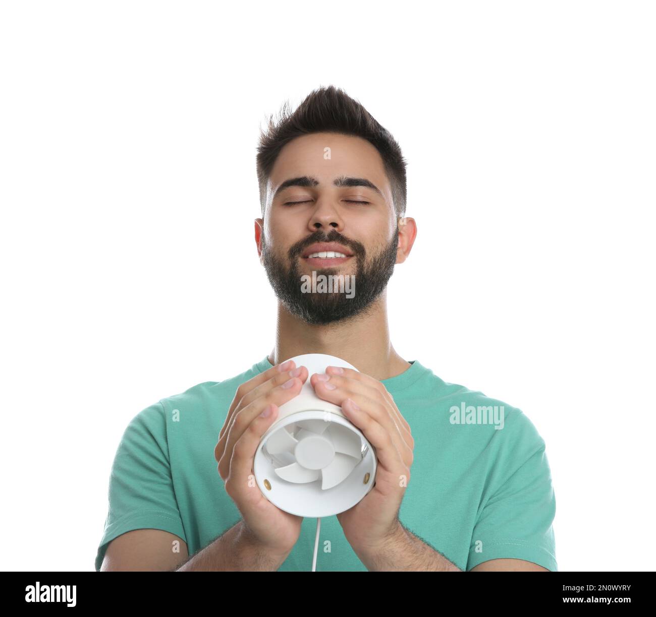Man enjoying air flow from portable fan on white background. Summer ...