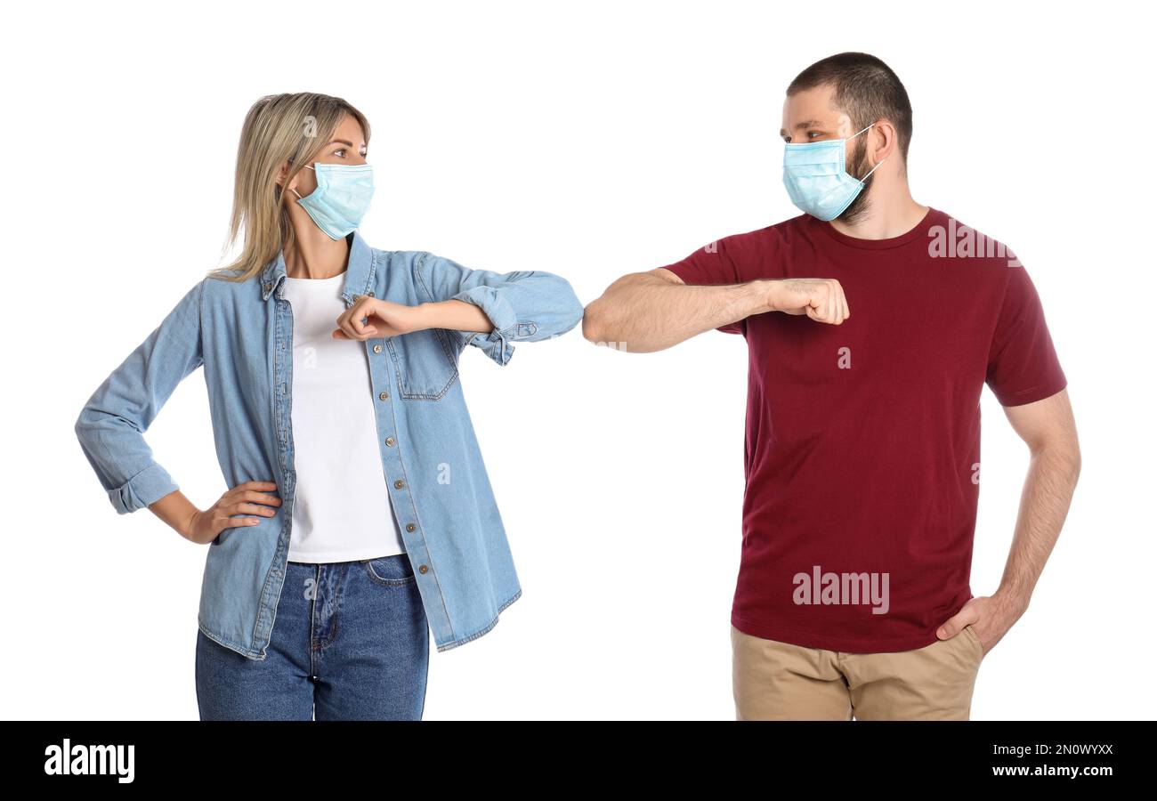 Man and woman bumping elbows to say hello on white background. Keeping ...