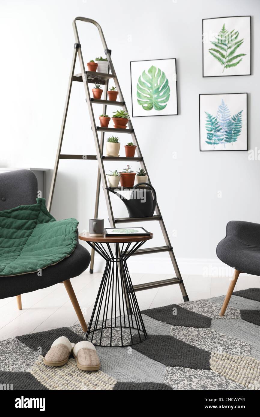 Stylish living room interior with decorative ladder Stock Photo - Alamy