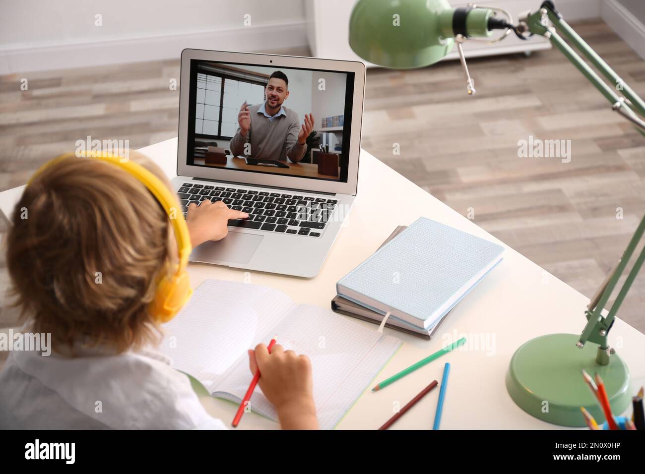 Little boy studying with teacher via video conference at home. Distance ...