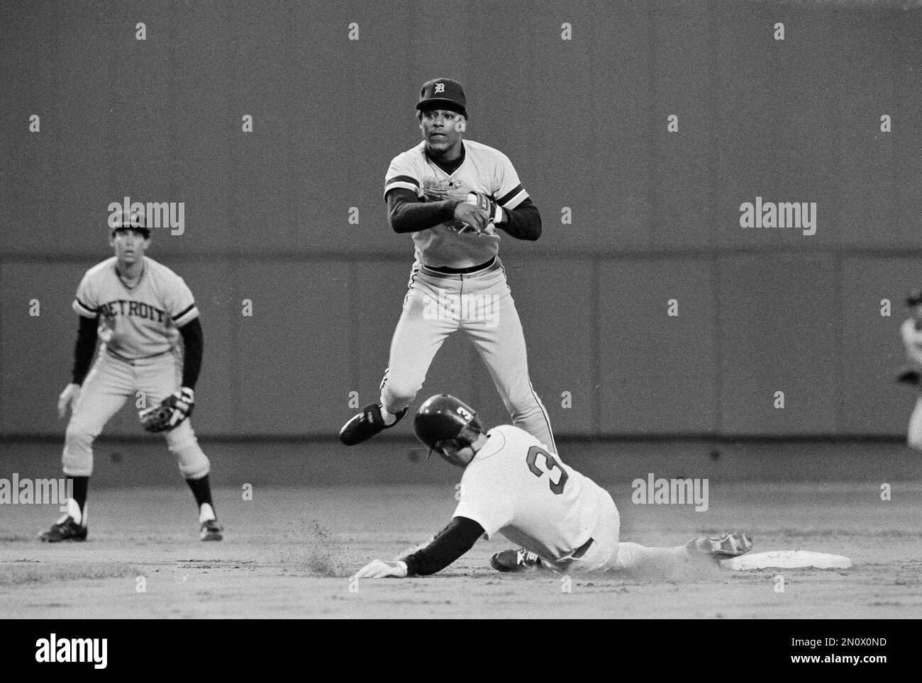 Detroit's Lou Whitaker successfully completes the double play despite ...