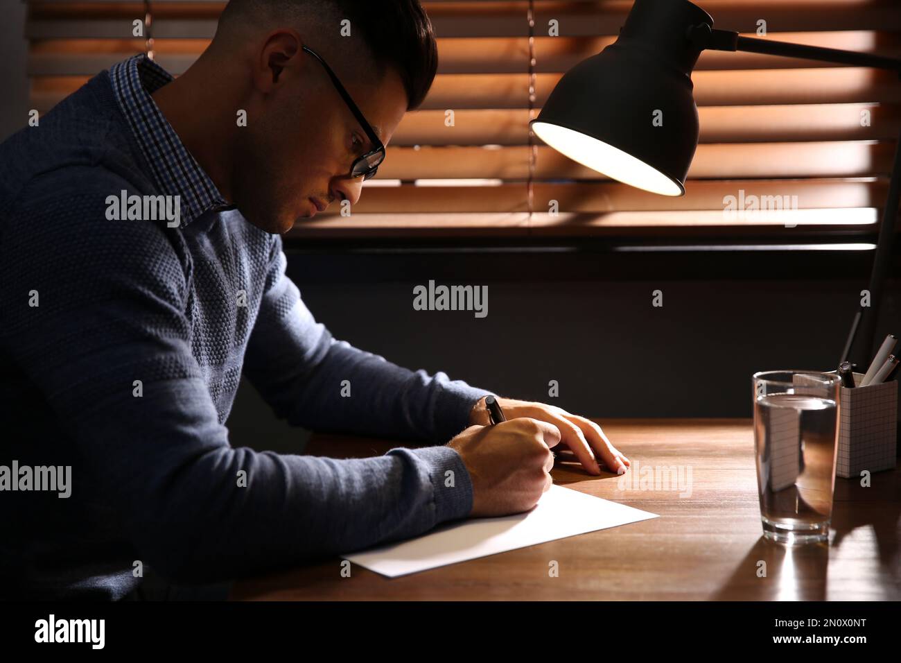 Man writing letter in home dark hi-res stock photography and images - Alamy