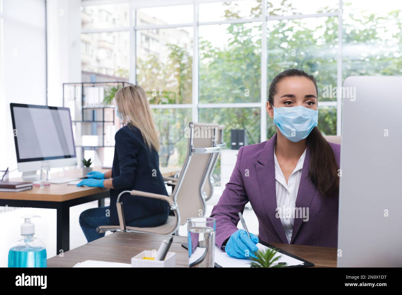 Office employees in masks and gloves at workplace Stock Photo - Alamy
