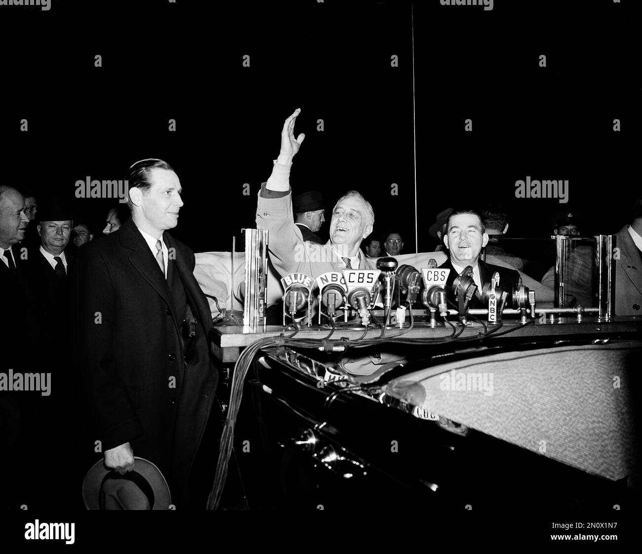 President Franklin D. Roosevelt waves farewell to the 40,000 persons ...