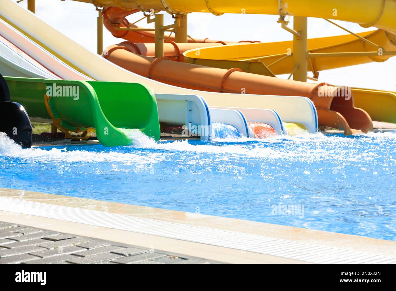 Different colorful slides in water park on sunny day Stock Photo - Alamy