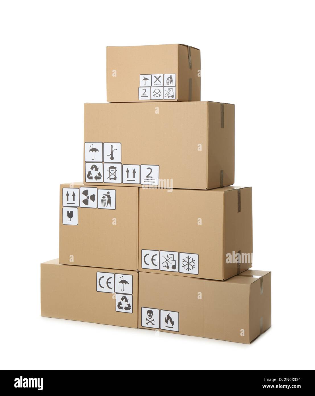 Stack of cardboard boxes with different packaging symbols on white ...