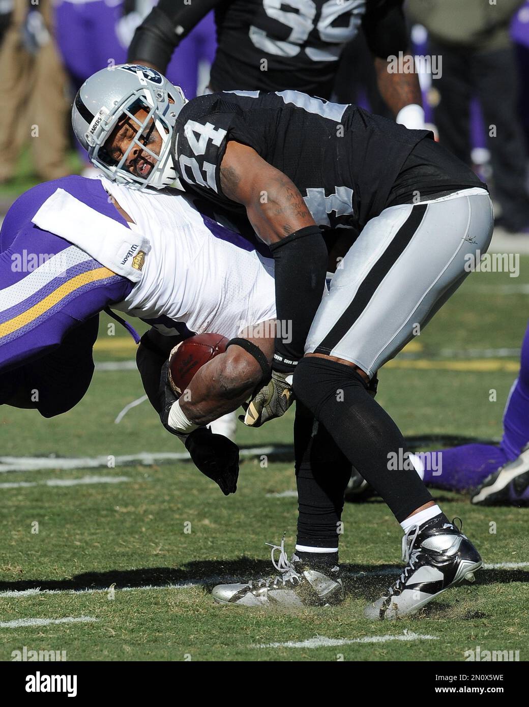 Oakland Raiders safety (24) Charles Woodson tackles Minnesota Vikings ...