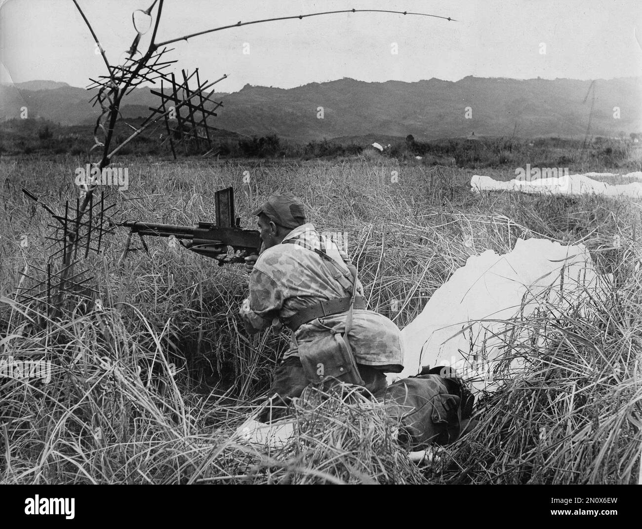 With his parachute lying beside him, a French paratrooper mans his ...