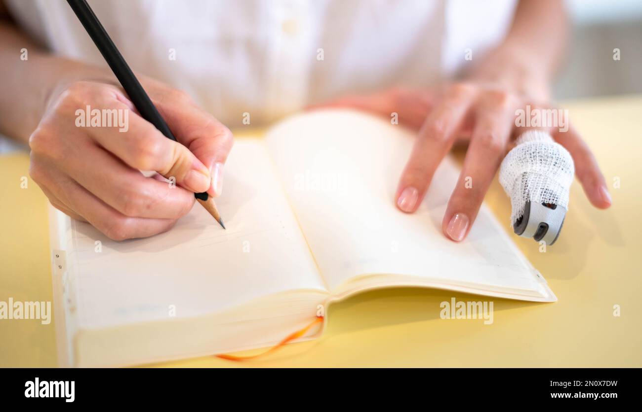 Females hand making notes with pencils and empty notebooks in their ...