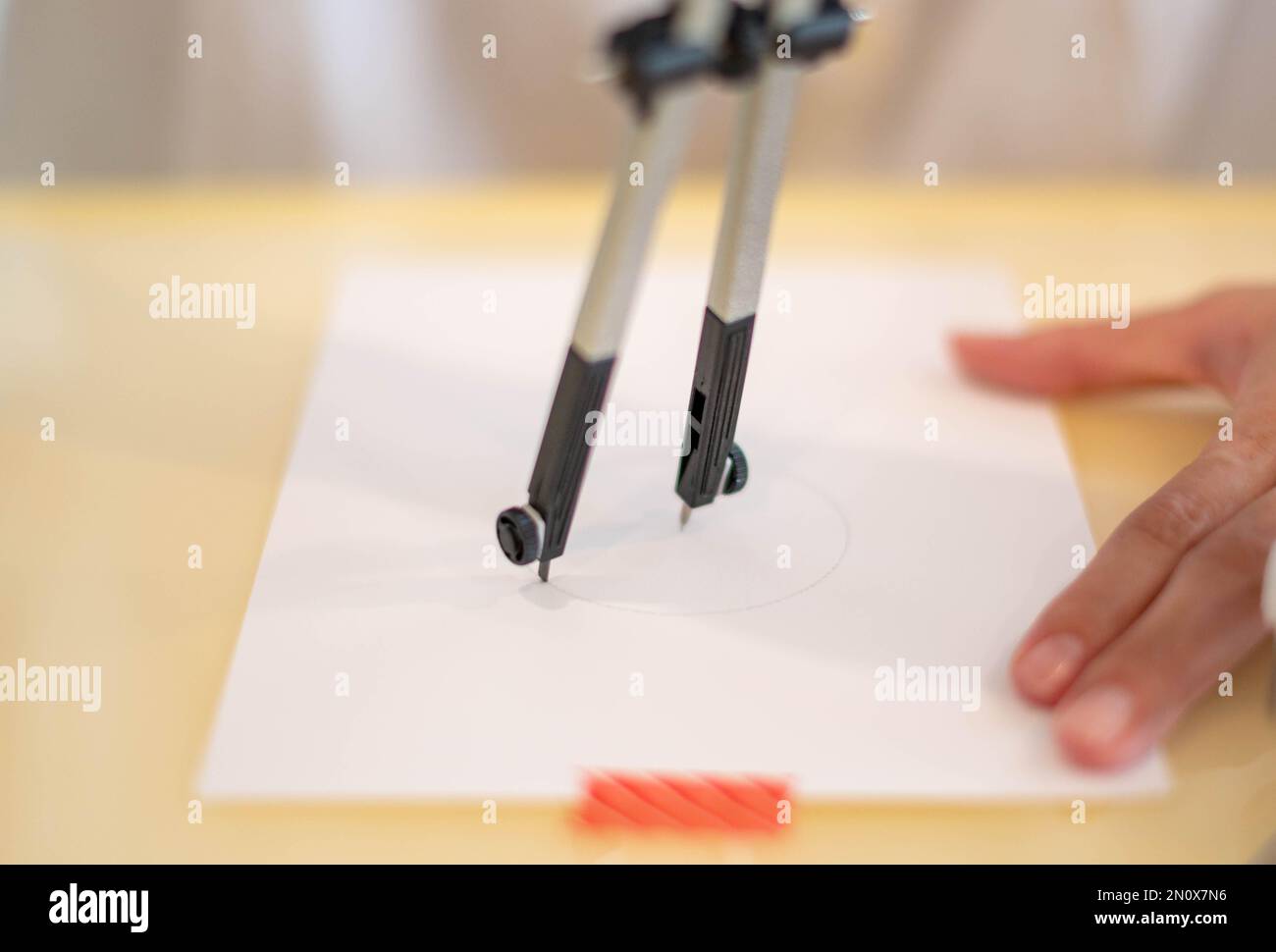 Female hand using a measure circle preparing to draw and sketch on the ...