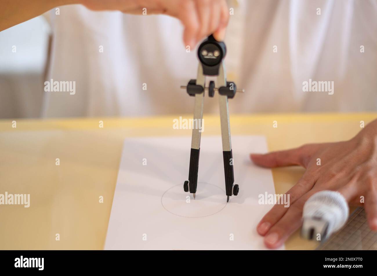 Female hand using a measure circle preparing to draw and sketch on the ...