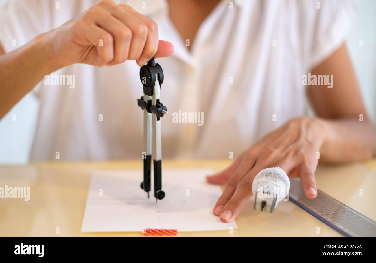Female hand using a measure circle preparing to draw and sketch on the ...