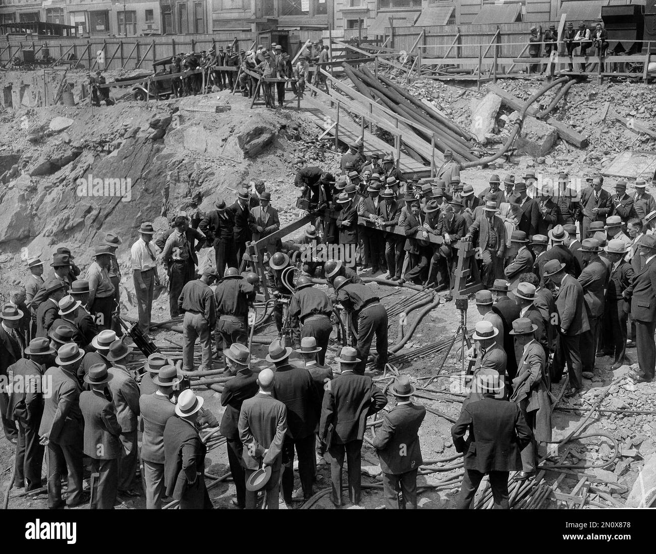 Construction worker and onlookers watch as a new dust eliminator from ...