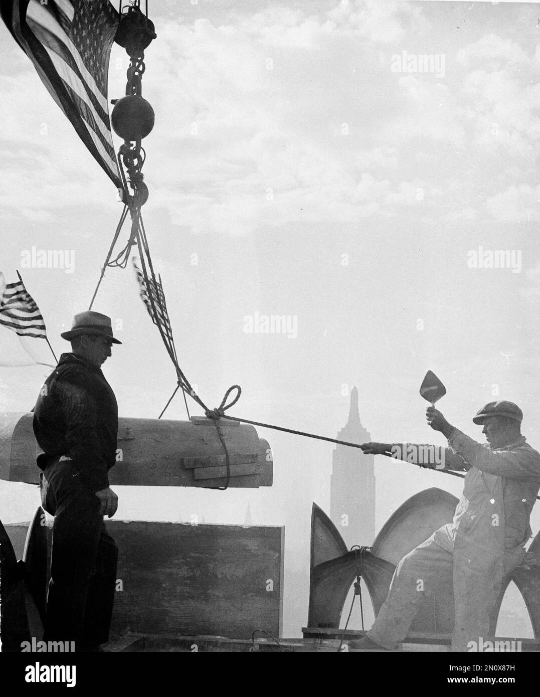 Construction workers atop the nearly completed 70-story RCA Building ...