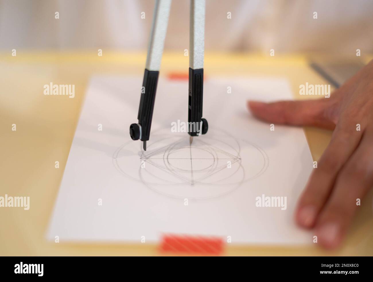 Female hand using a measure circle preparing to draw and sketch on the ...