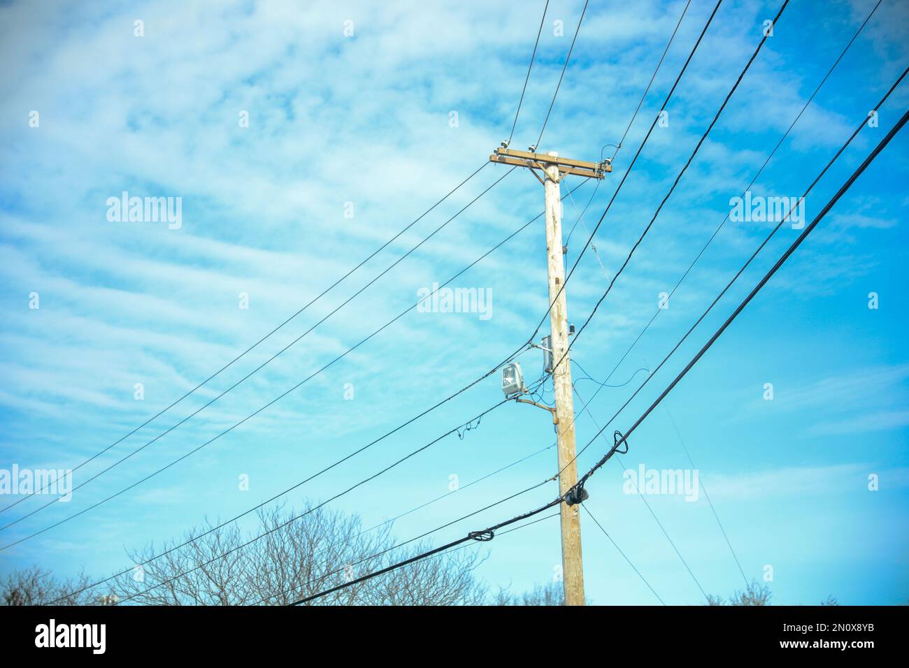 Electric power lines in the clear blue sky Stock Photo - Alamy