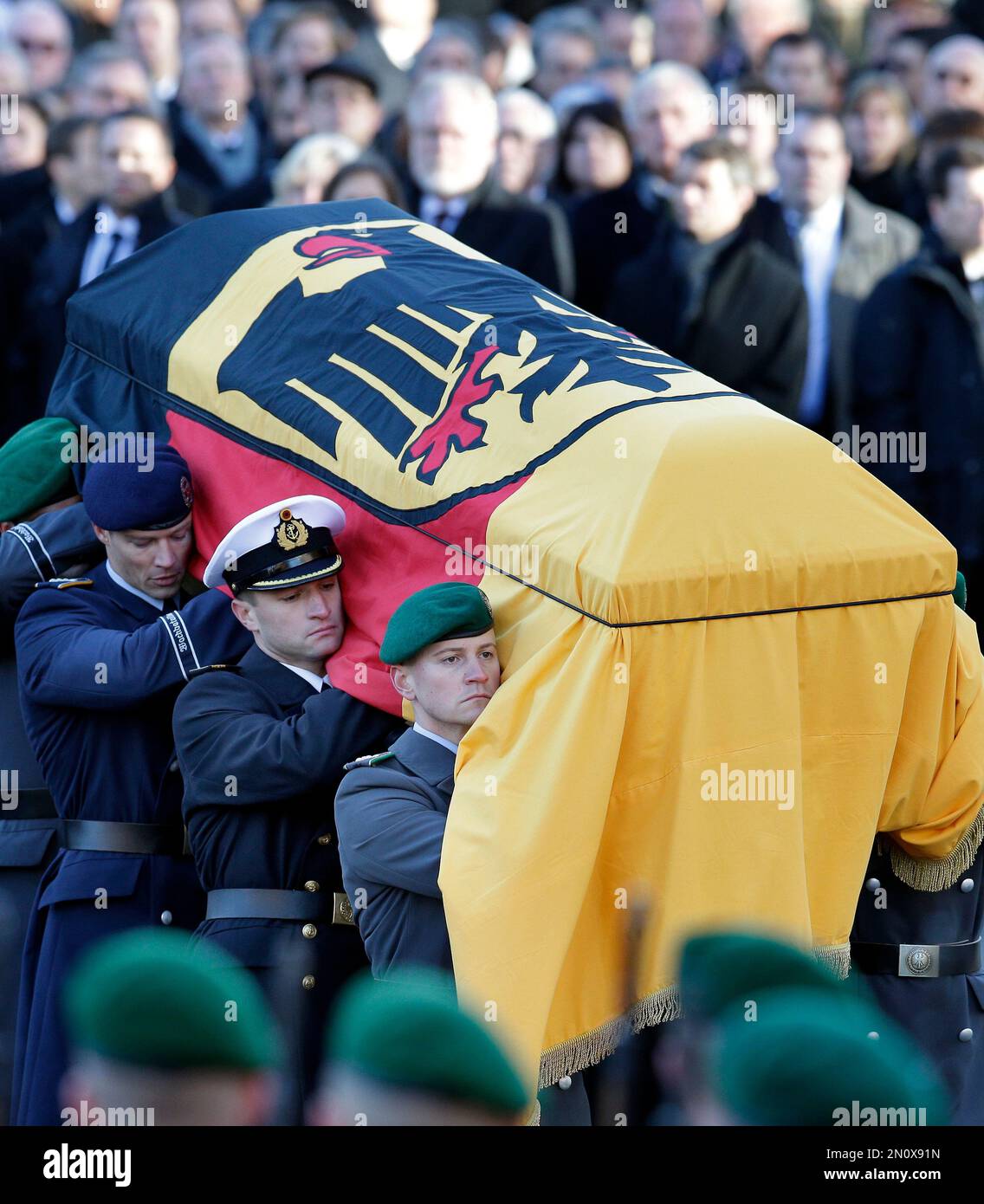 Soldiers carry the coffin covered with a German flag after the official ...