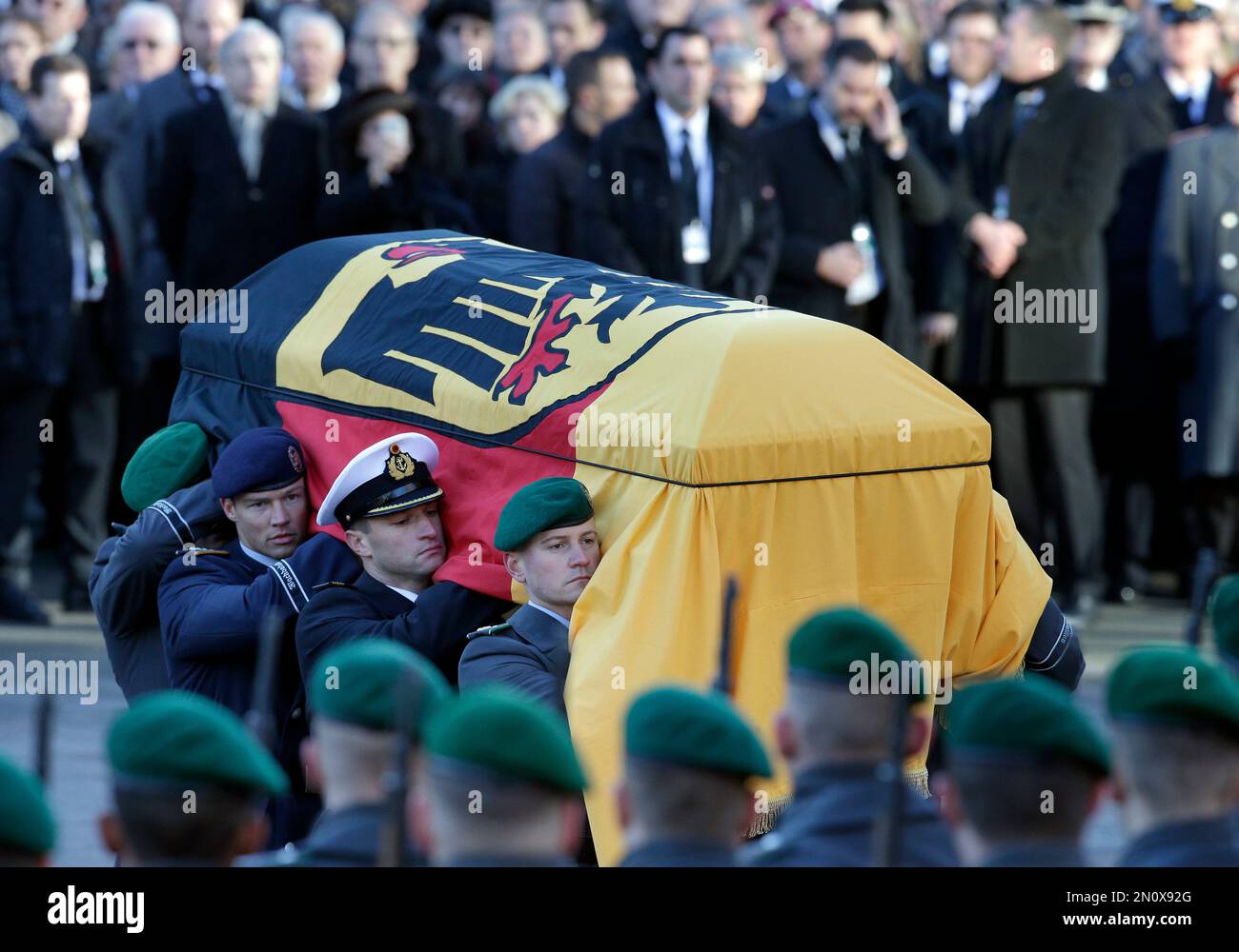 Soldiers carry the coffin covered with a German flag after the official ...