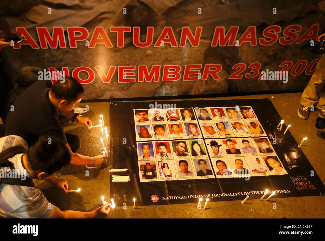 Philippine journalists light candles for the 32 journalists and media workers who were killed in ...