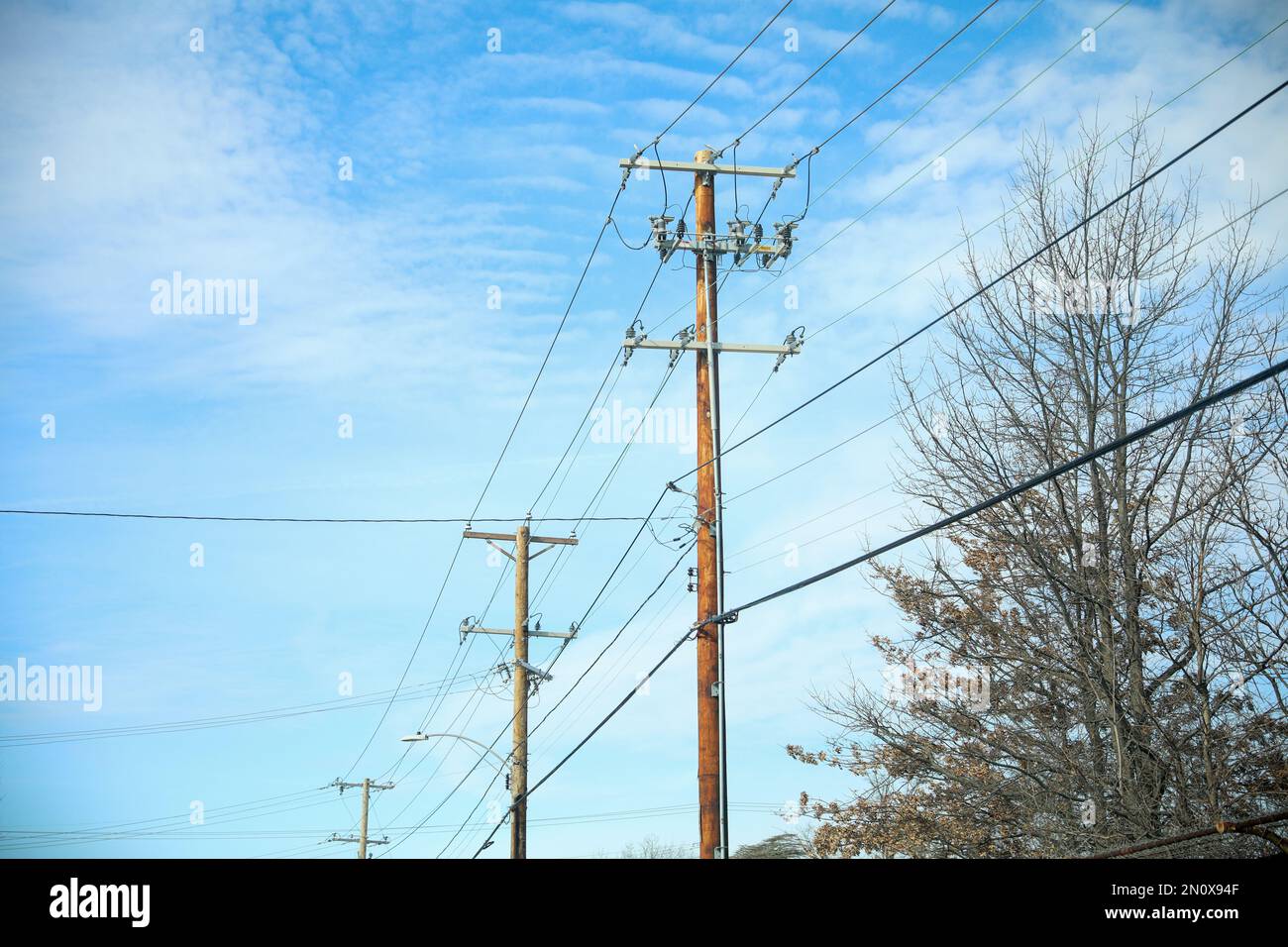 Electric power lines in the clear blue sky Stock Photo - Alamy