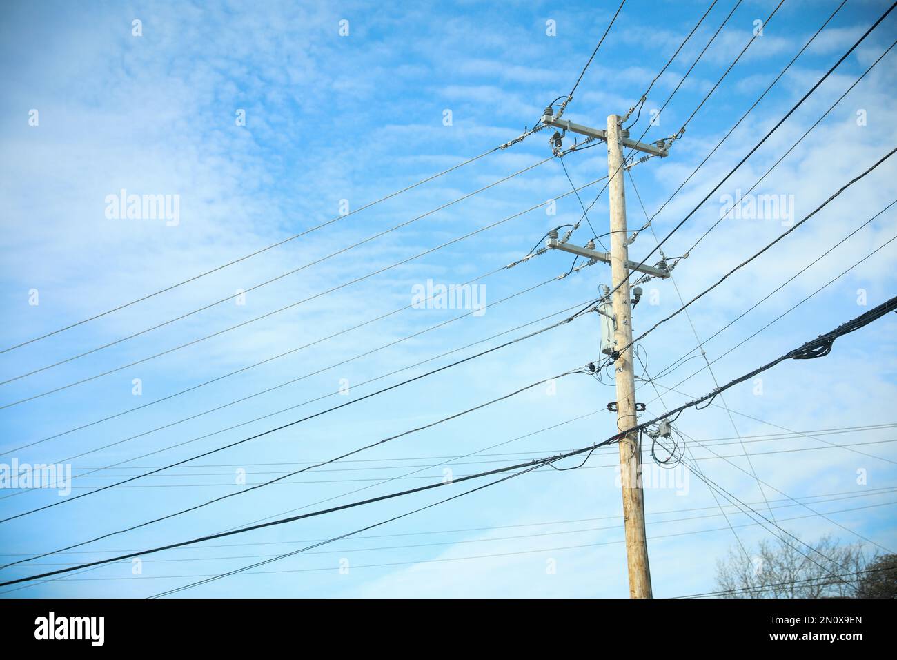 Electric power lines in the clear blue sky Stock Photo - Alamy