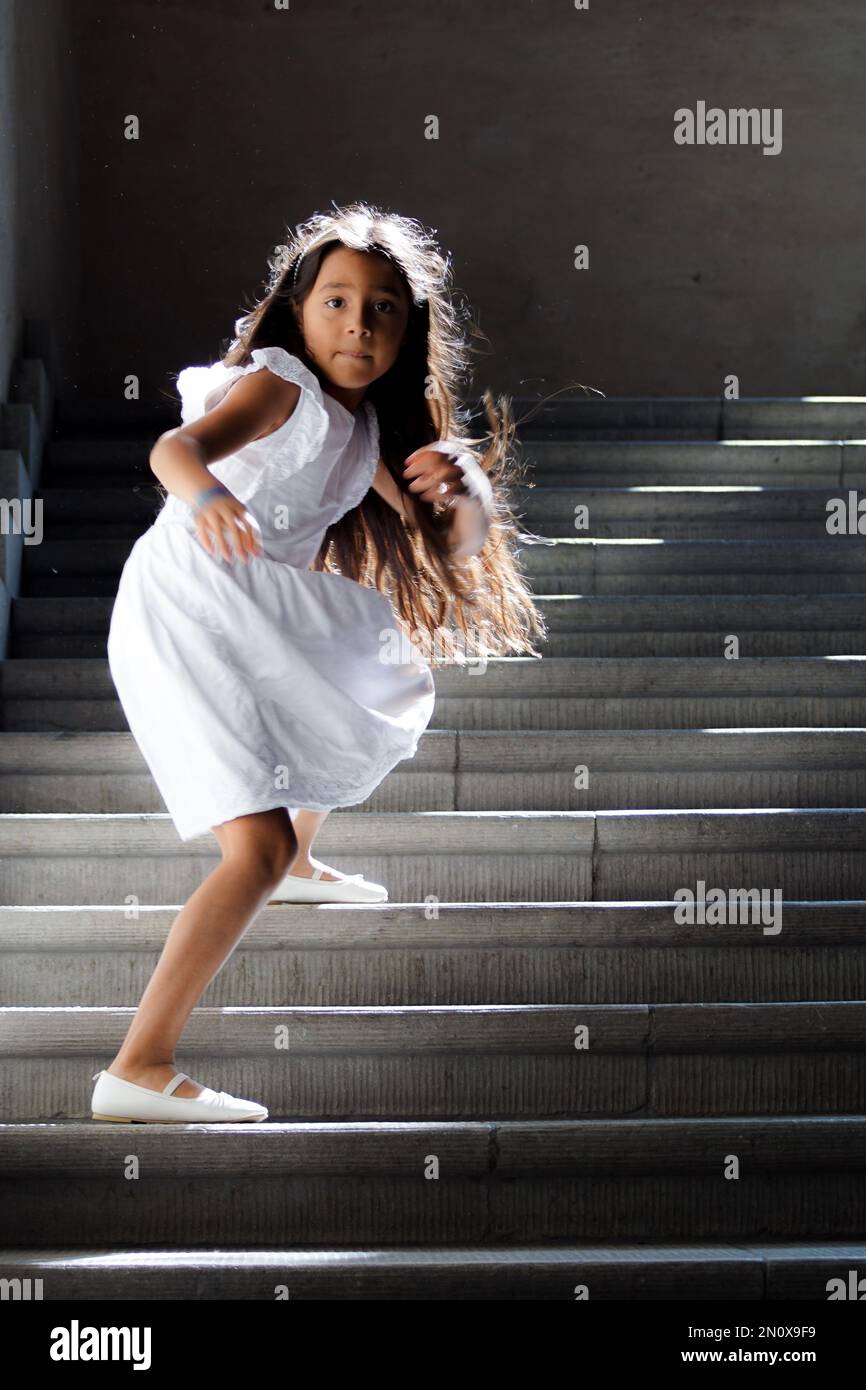 Girl in the dress standing on stairs Stock Photo - Alamy