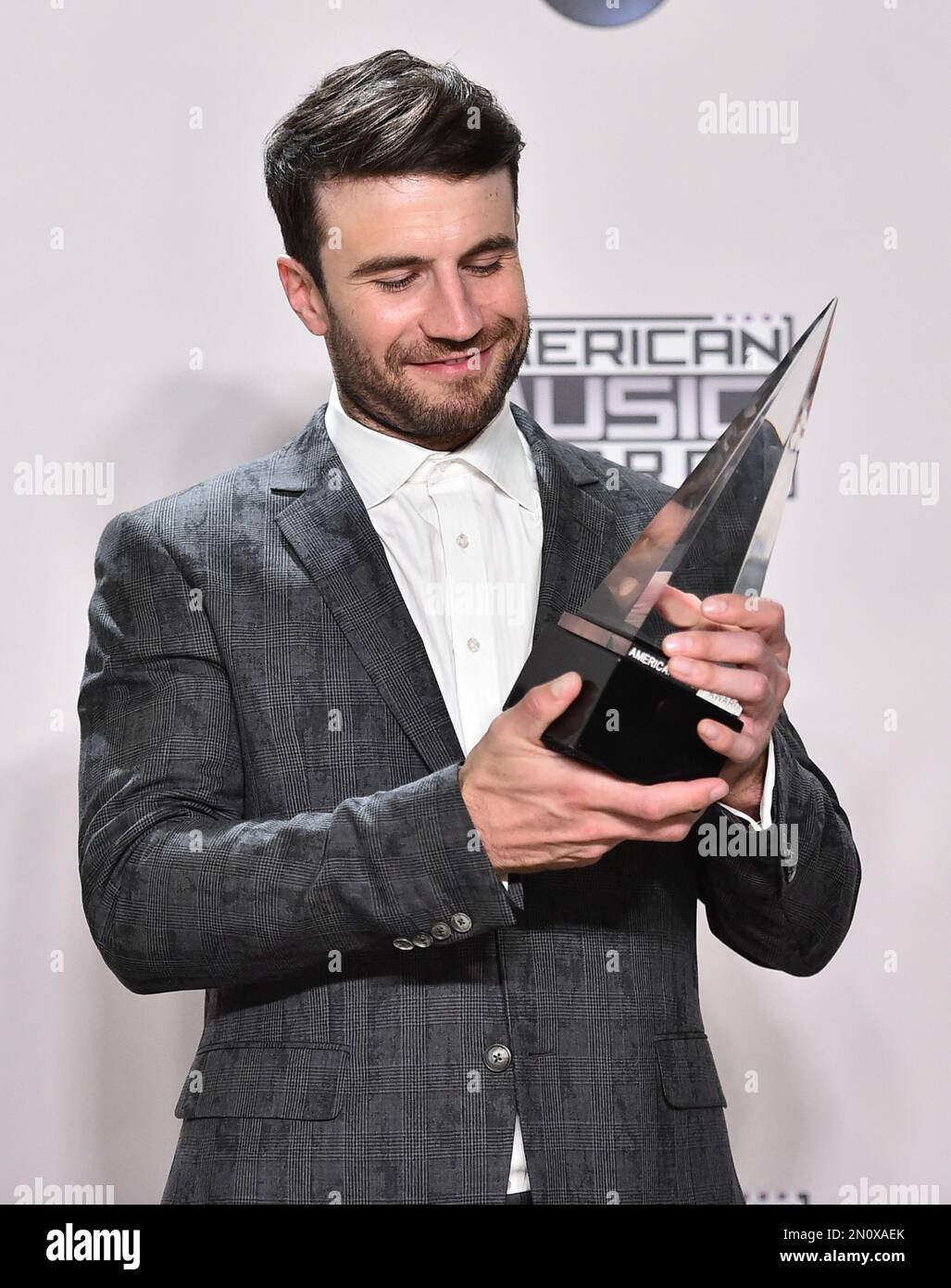 Sam Hunt poses in the press room with the award for new artist of the year at the American Music ...