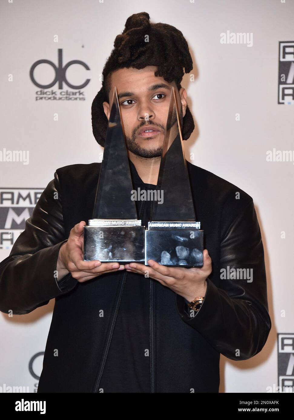 The Weeknd poses in the press room with the awards for best soul/R&B ...