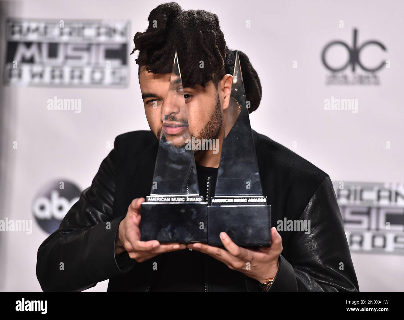The Weeknd poses in the press room with the awards for best soul/R&B ...