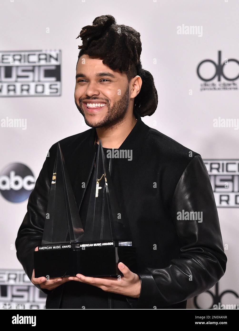 The Weeknd poses in the press room with the awards for best soul/R&B ...