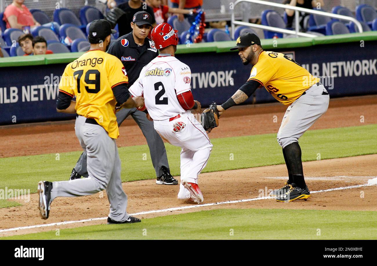 Cardenales' Elvis Escobar (2) is caught in a rundown by Aguilas third ...