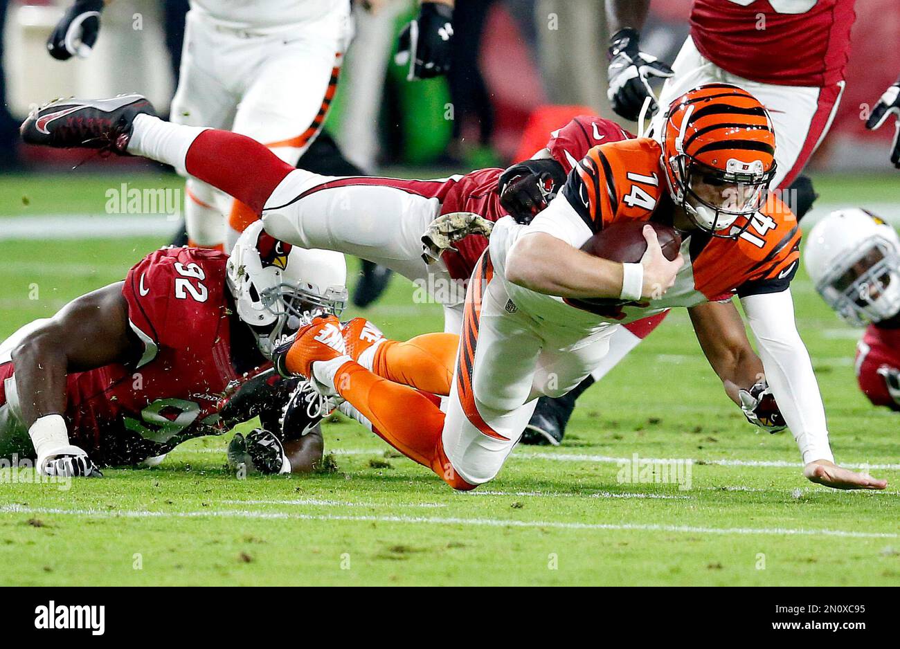 Cincinnati Bengals quarterback Andy Dalton (14) is tackled by Arizona ...