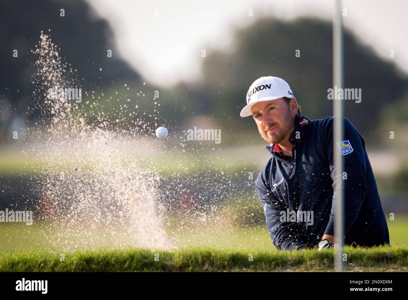 Graeme McDowell, of Northern Ireland, hits his ball out of the bunker ...