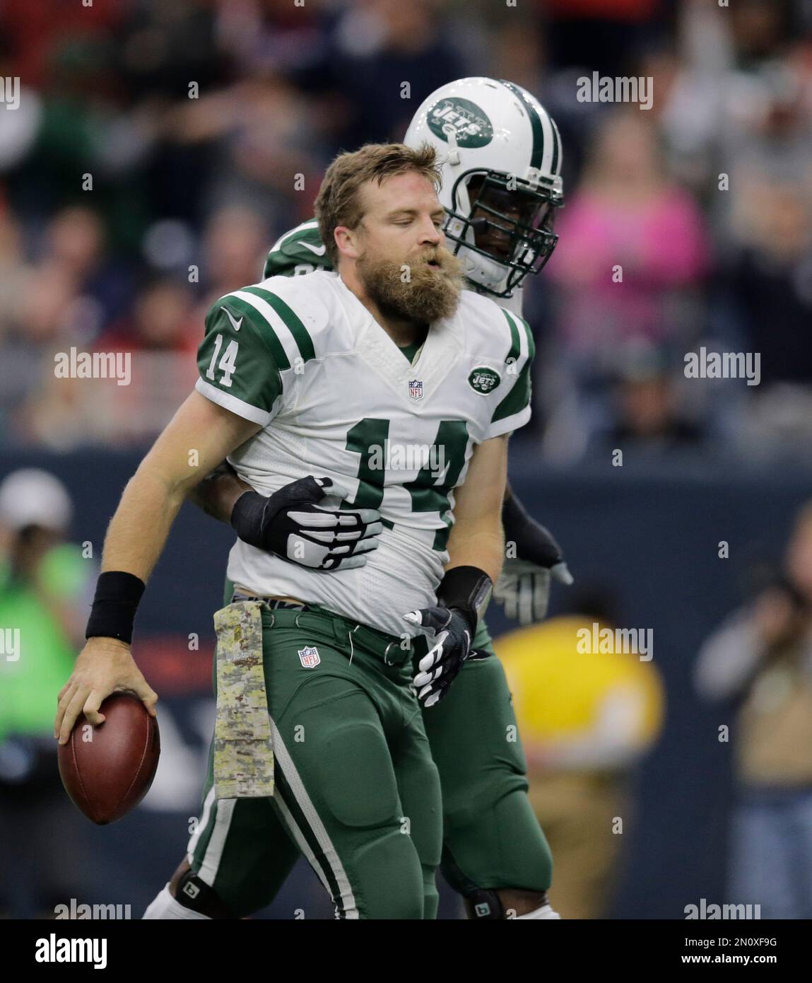 New York Jets quarterback Ryan Fitzpatrick (14) comes up without his ...