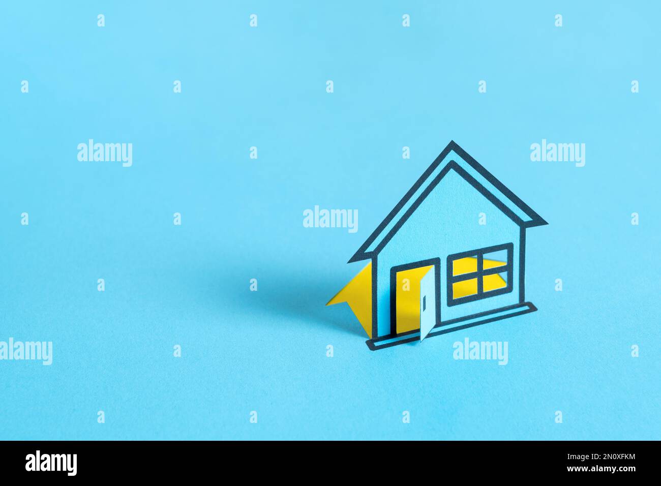 Paper house on blank blue background Stock Photo - Alamy