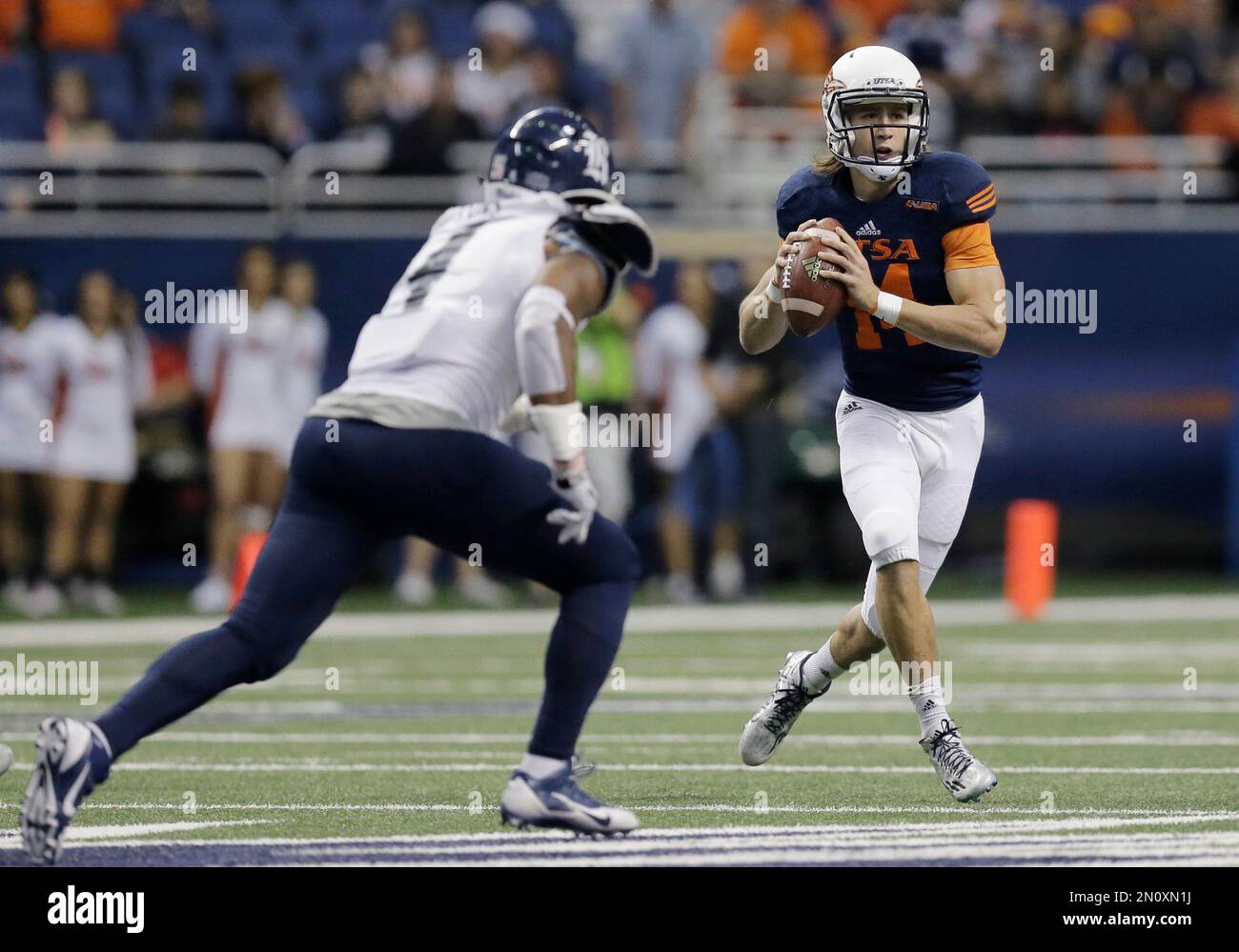 UTSA quarterback Dalton Sturm (14) is pressured by Rice linebacker Alex ...