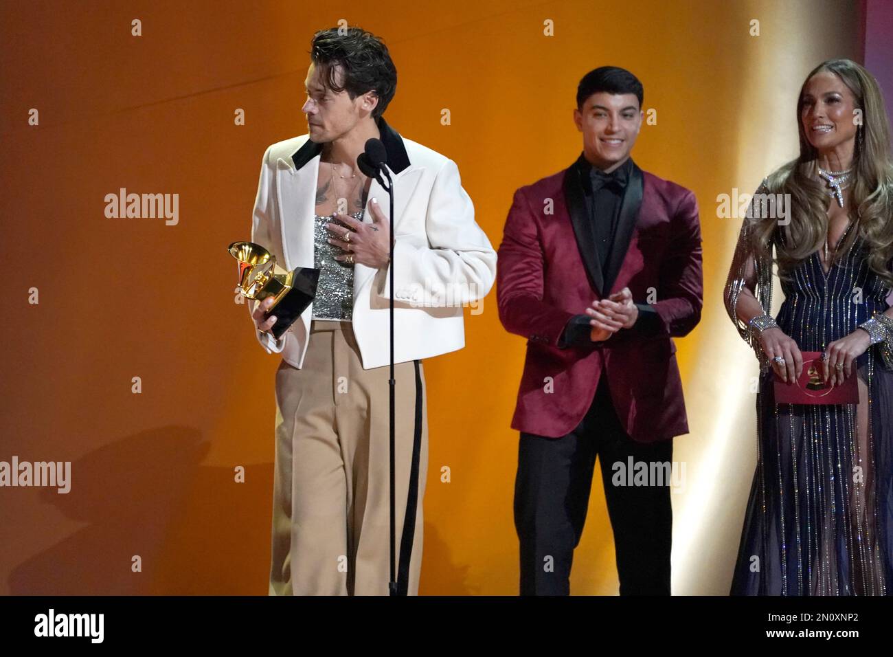 Harry Styles, left, accepts the award for best pop vocal album for ...
