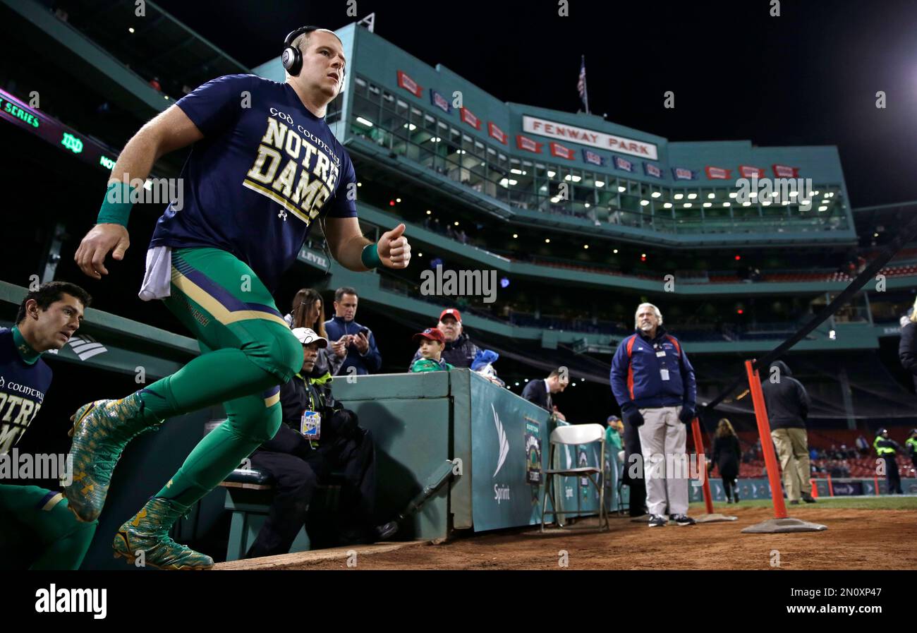 Notre Dame long snapper Scott Daly runs up the dugout steps onto the field prior to the Shamrock ...