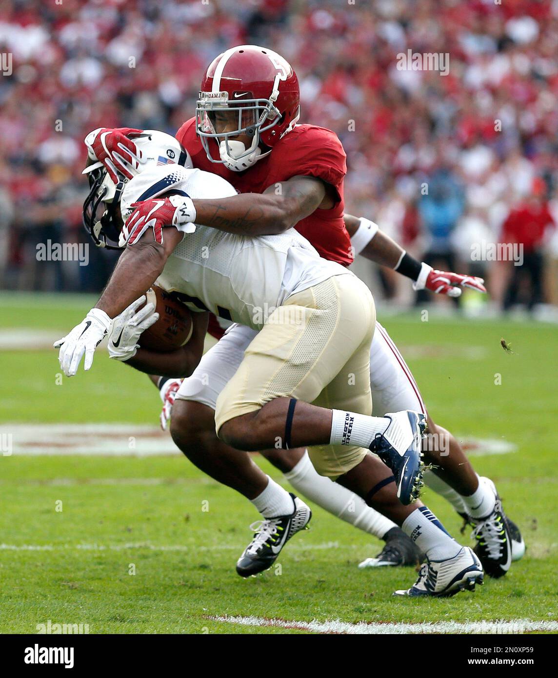 Alabama defensive back Cyrus Jones (5) tackles Charleston Southern ...