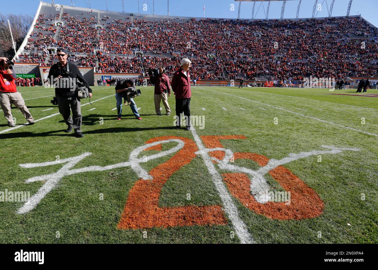 Virginia Tech head coach Frank Beamer walks past his number and ...