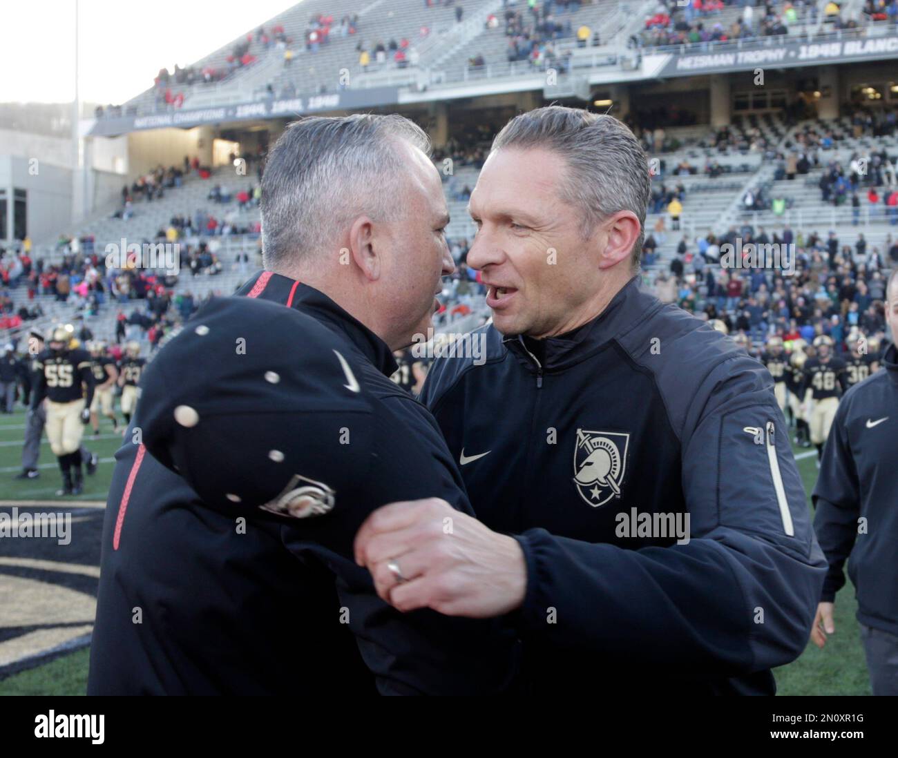 Rutgers head coach Kyle Flood, left, and Army head coach Jeff Monken ...