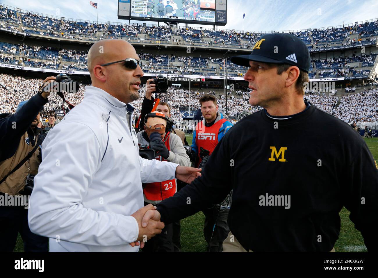 Michigan head coach Jim Harbaugh, right shakes hands with Penn State ...