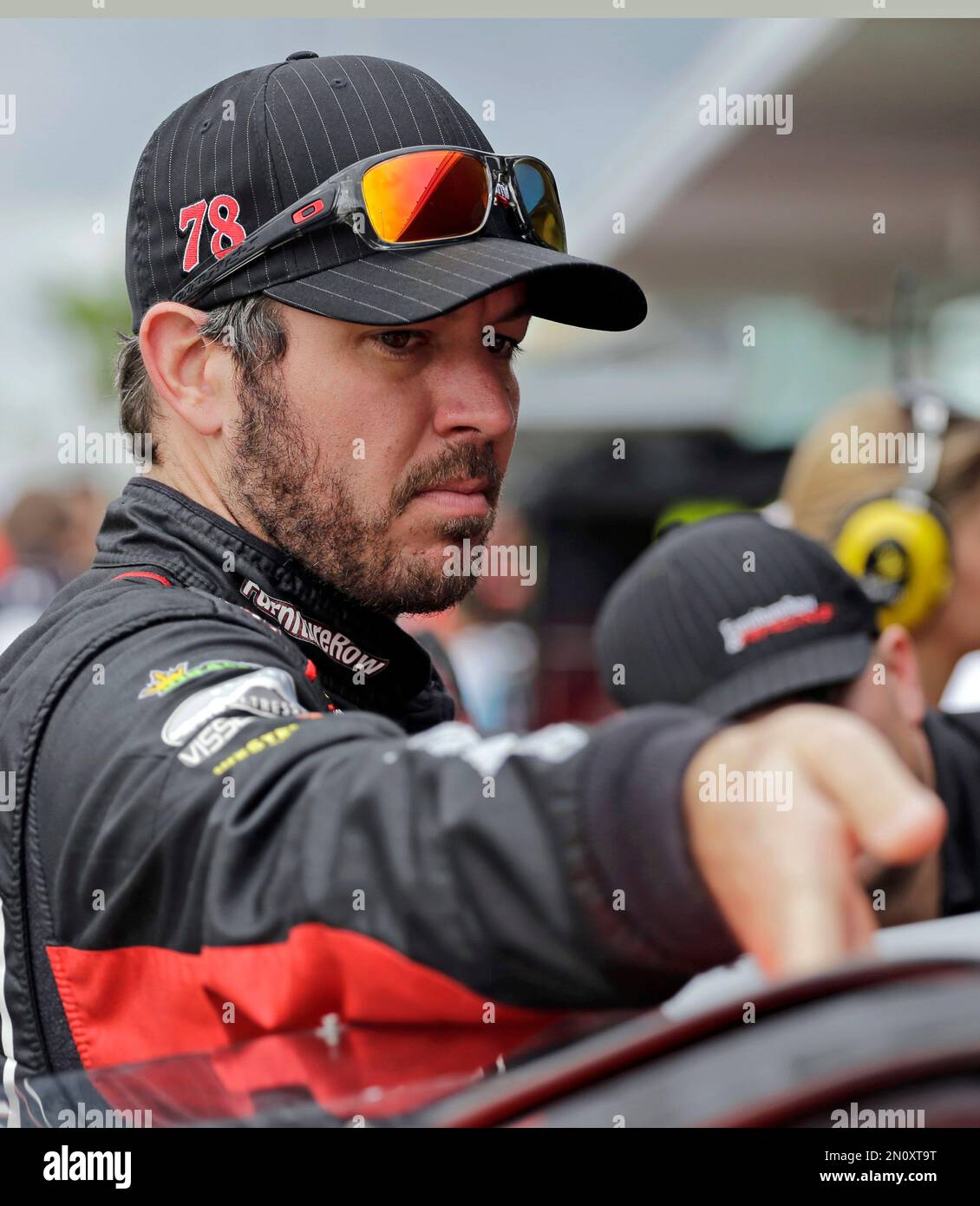 Martin Truex, Jr., checks his car in the garage area before the NASCAR ...