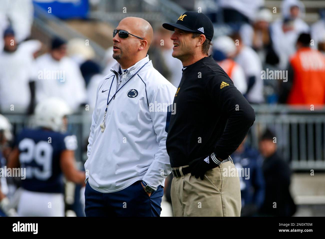 Michigan head coach Jim Harbaugh, right visits with Penn State head ...